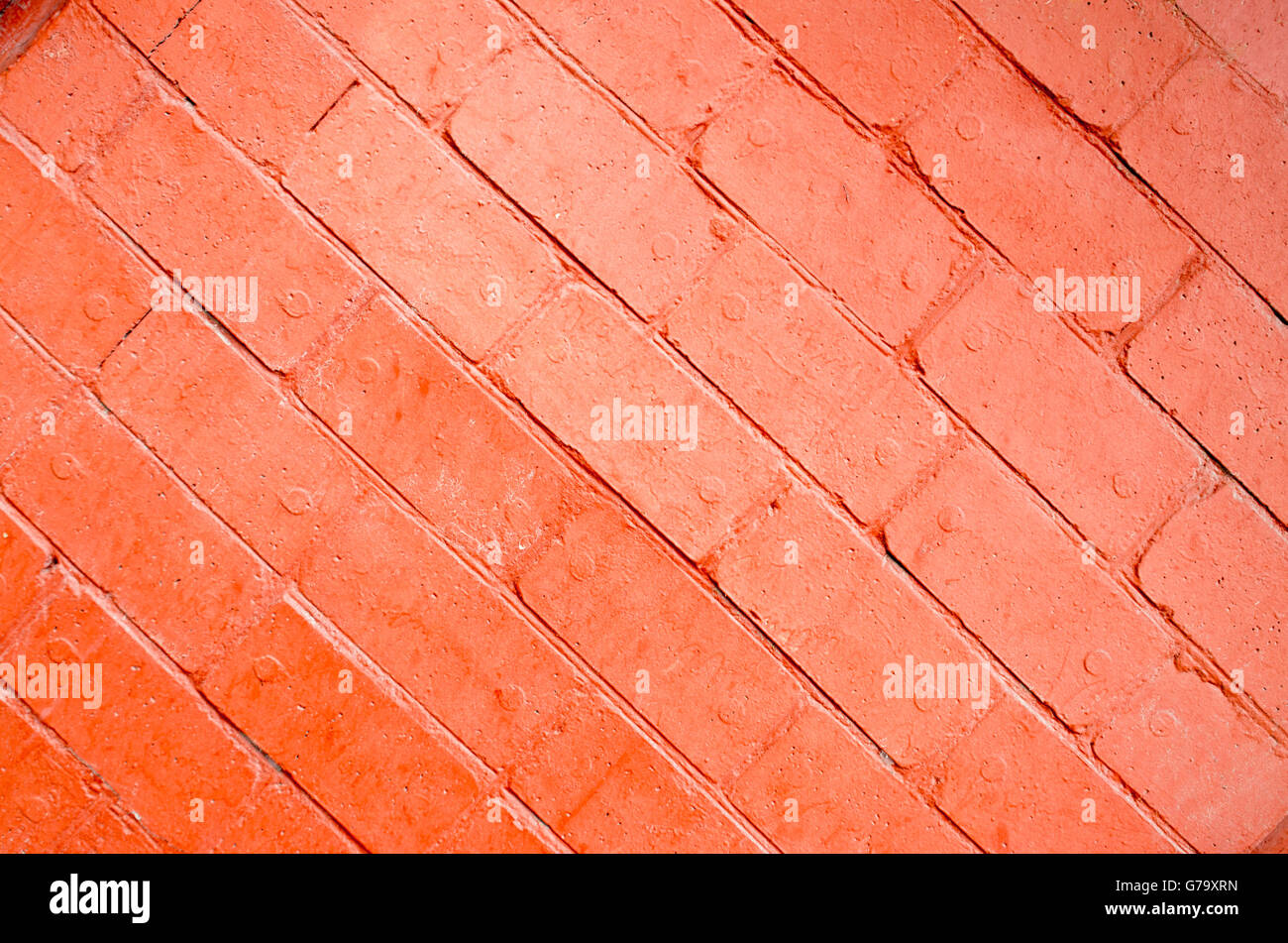 Red background of bricks on a diagonal image with a layer of paint ...