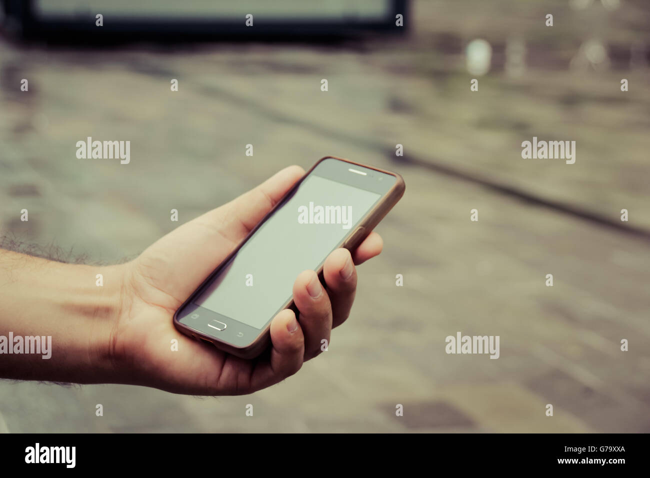 Photograph of a human hand holding a cellphone Stock Photo - Alamy