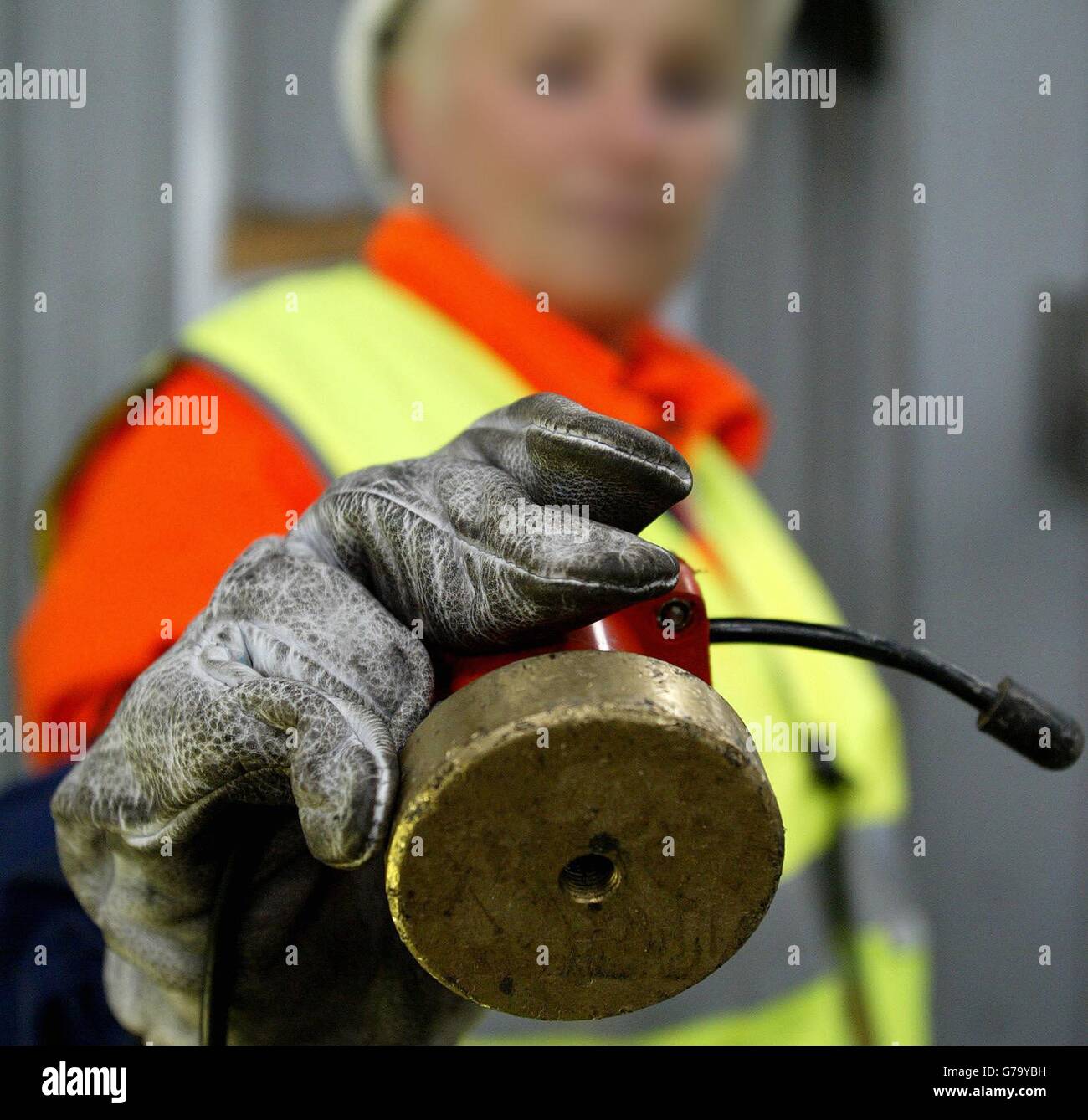 An Immigration officer demonstrates the tiny heart beat monitor which ...