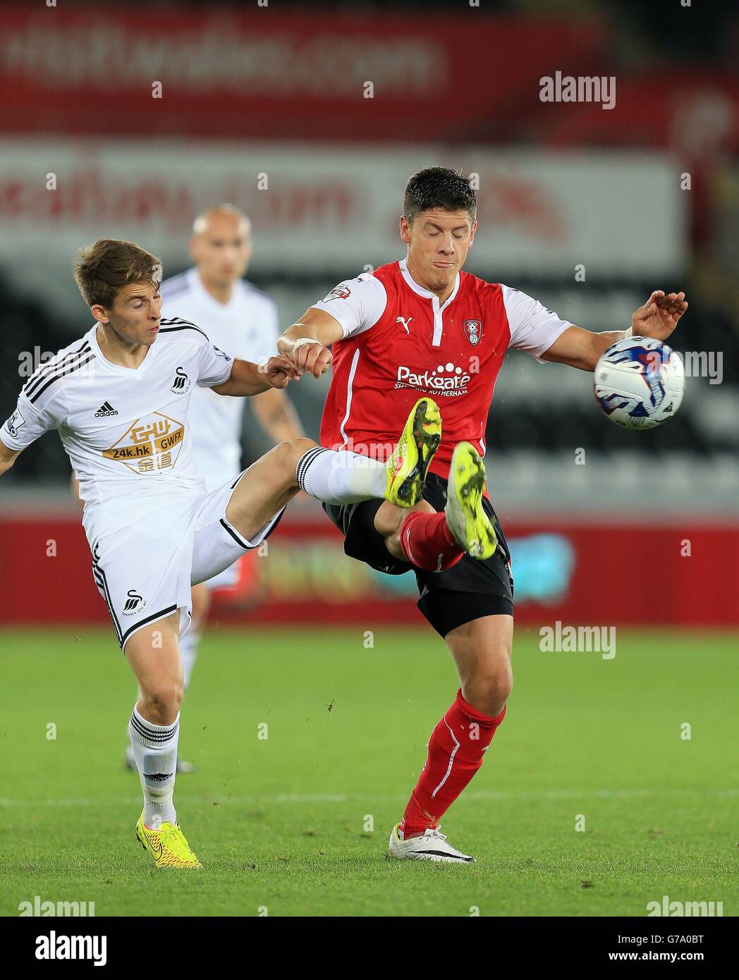 Rotherham United's Alex Revell is challenged by Swansea City's Tom ...