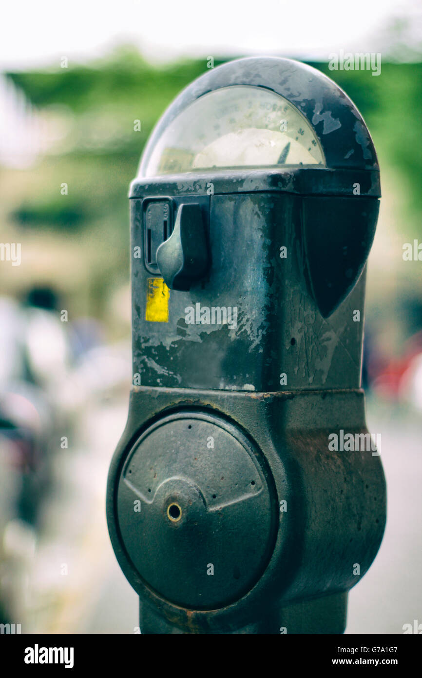 Photograph of an old metal parking meter on a sidewalk Stock Photo - Alamy