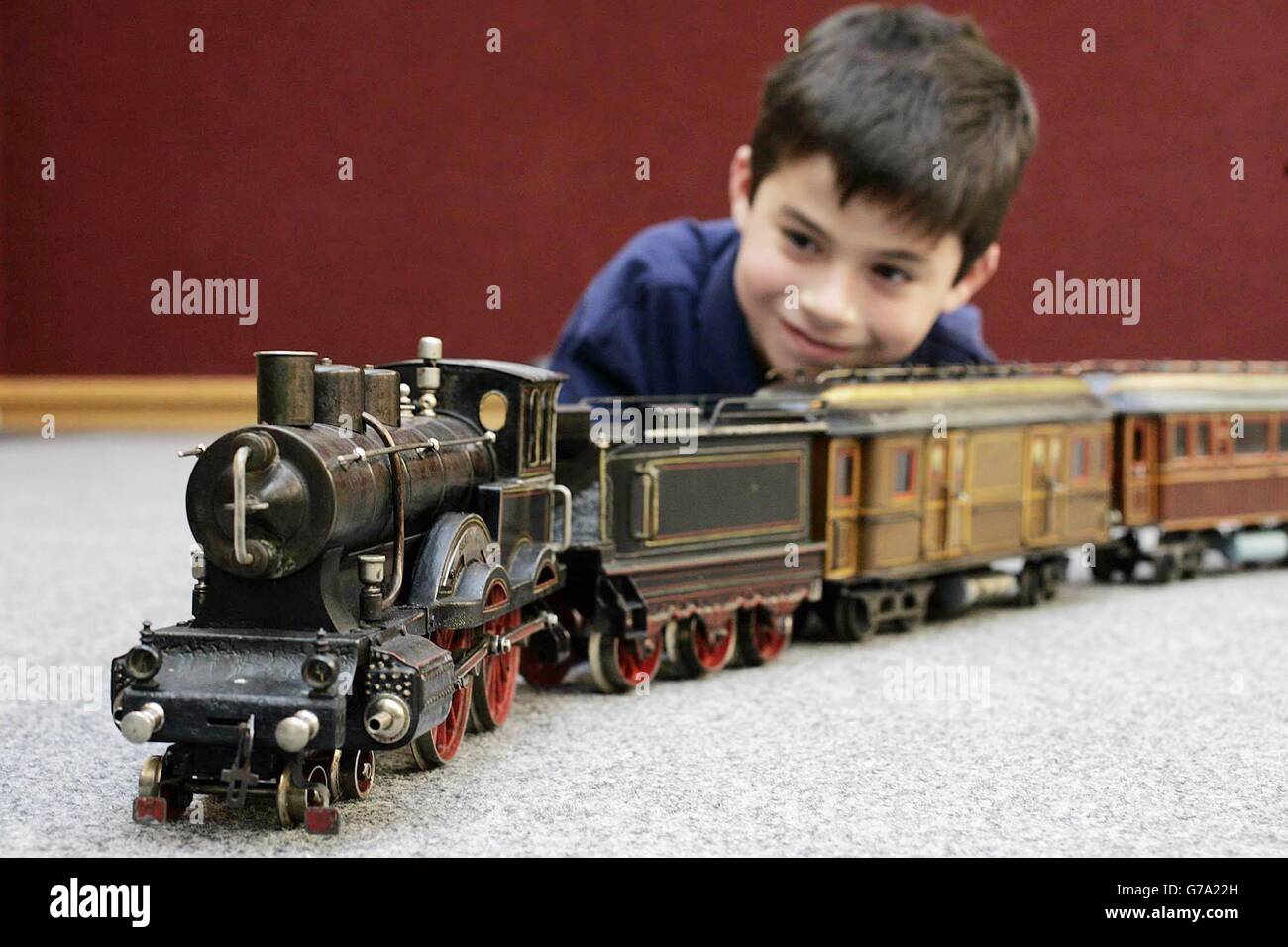 Ian Scoville, 7, looking at a rare "Black Prince" locomotive and six ...