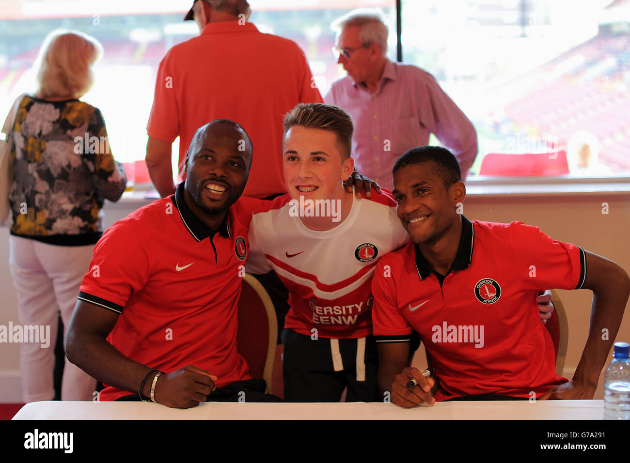 A young fan poses for photographs with Charlton Athletic's Andre Bikey ...