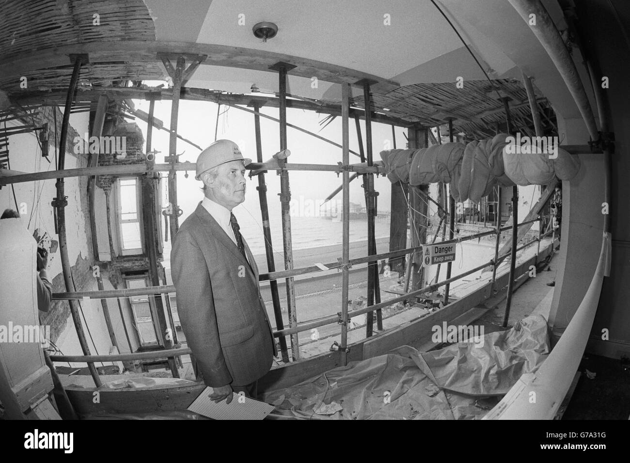 Derek Allen, Architects' Administrator, stands in the remains of the ...