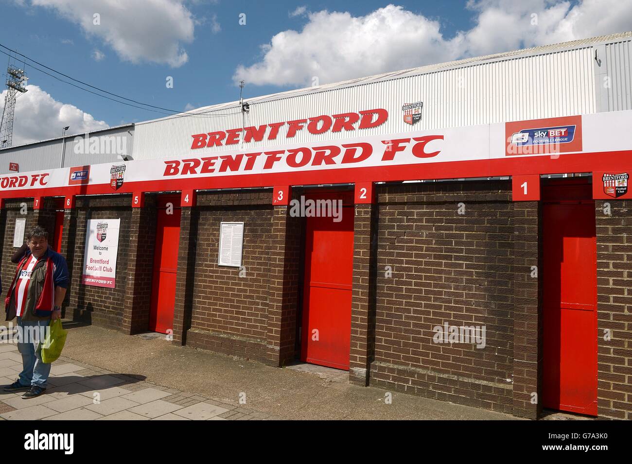 General view of a fan waiting outside Griffin Park before the game ...