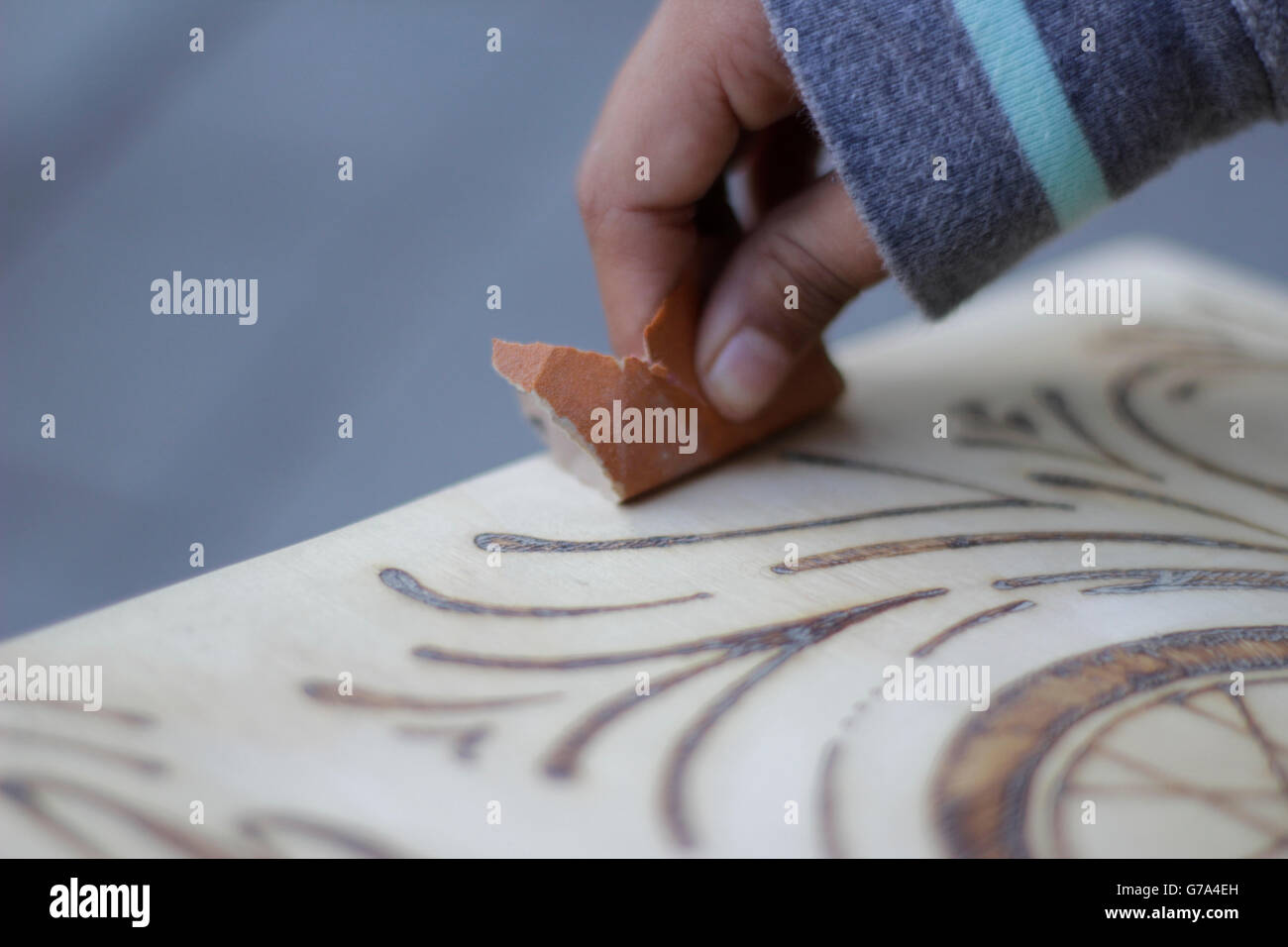Photograph of a human hand sanding wood Stock Photo - Alamy