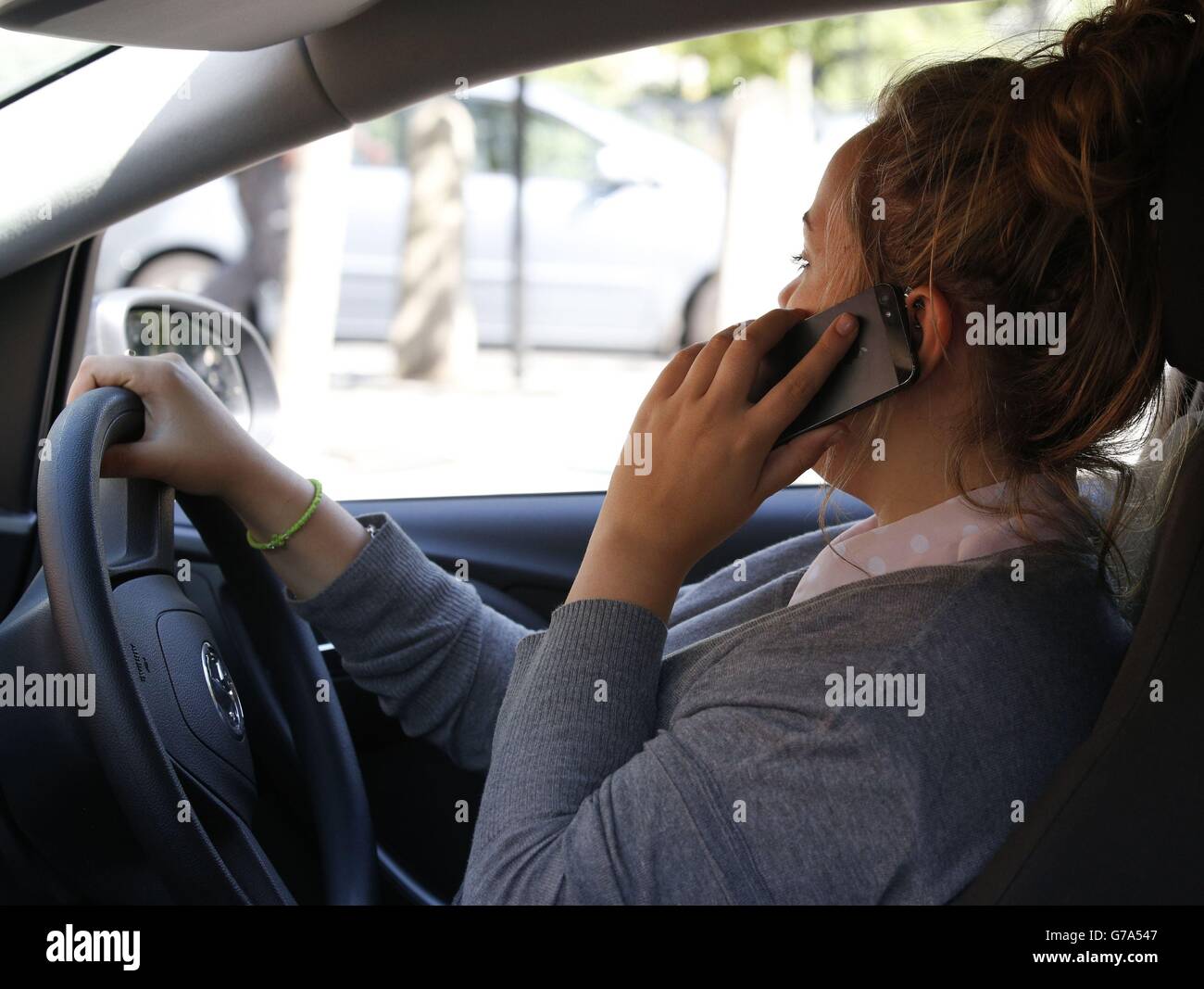 Driving stock. PICTURE POSED BY MODEL A woman talking on her phone ...