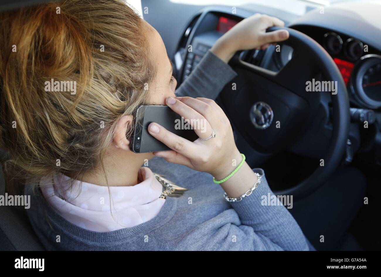 Driving stock. PICTURE POSED BY MODEL A woman talking on her phone ...