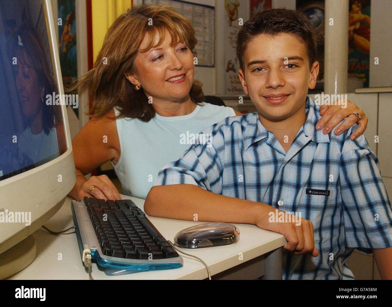 Adam Buckland, 13, from St Albans in Hertfordshire sits at his computer ...