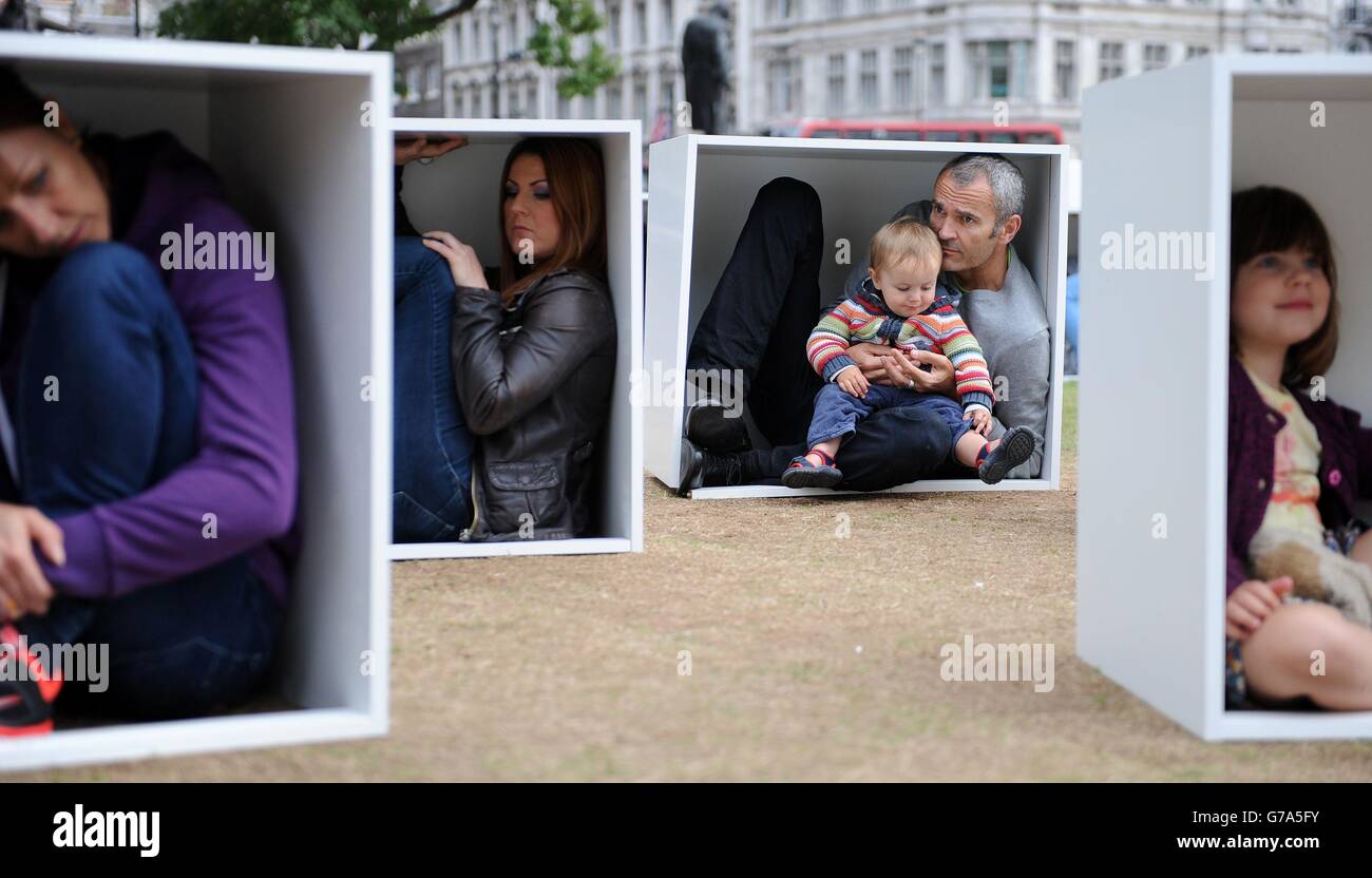 Men, women and children are squashed inside boxes to illustrate the ...
