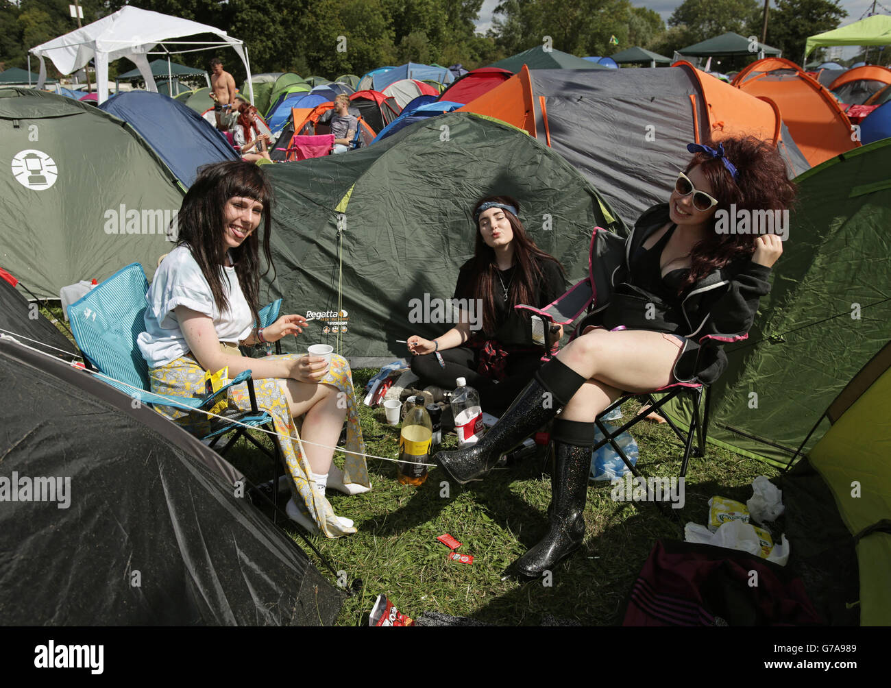 Festival goers relaxing by their tents at the Reading Festival, at ...