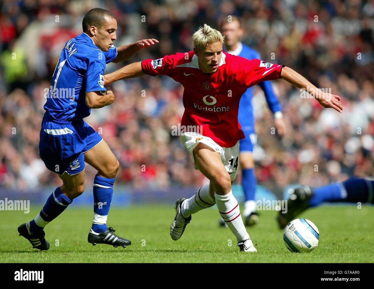 Manchester United's Alan Smith holds off Everton's Leon Osman, during ...