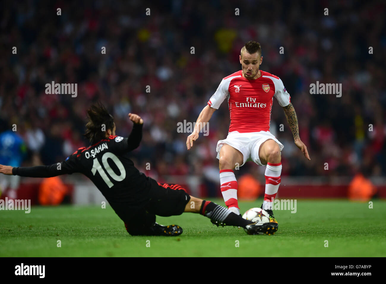 Arsenal's Mathieu Debuchy and Besiktas' Olcay Sahan (left) battle for ...