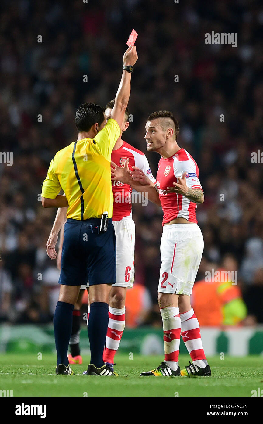 Arsenal's Mathieu Debuchy (right) is shown the red card by referee ...