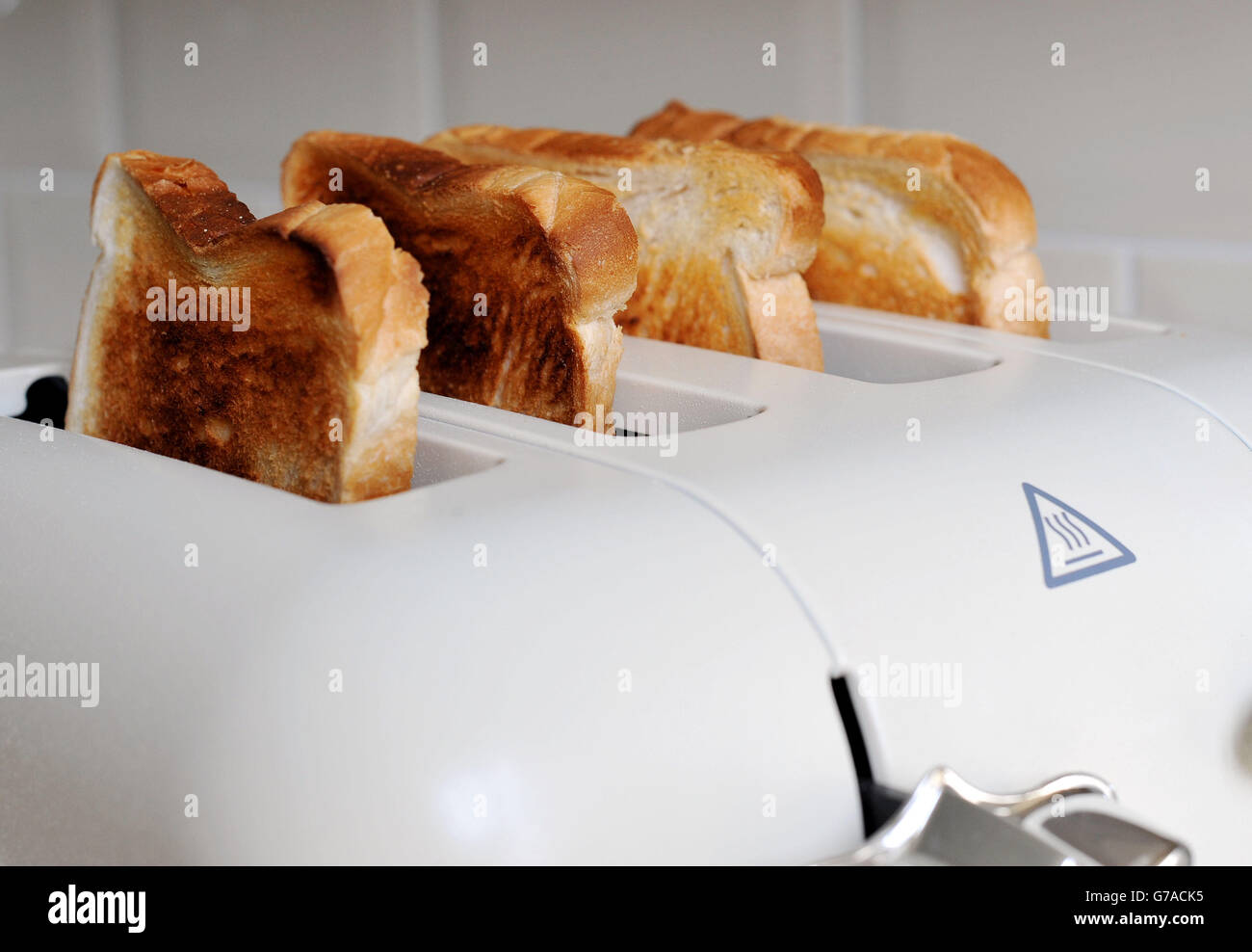 Four slices of white toasted bread in a four slice toaster Stock Photo ...