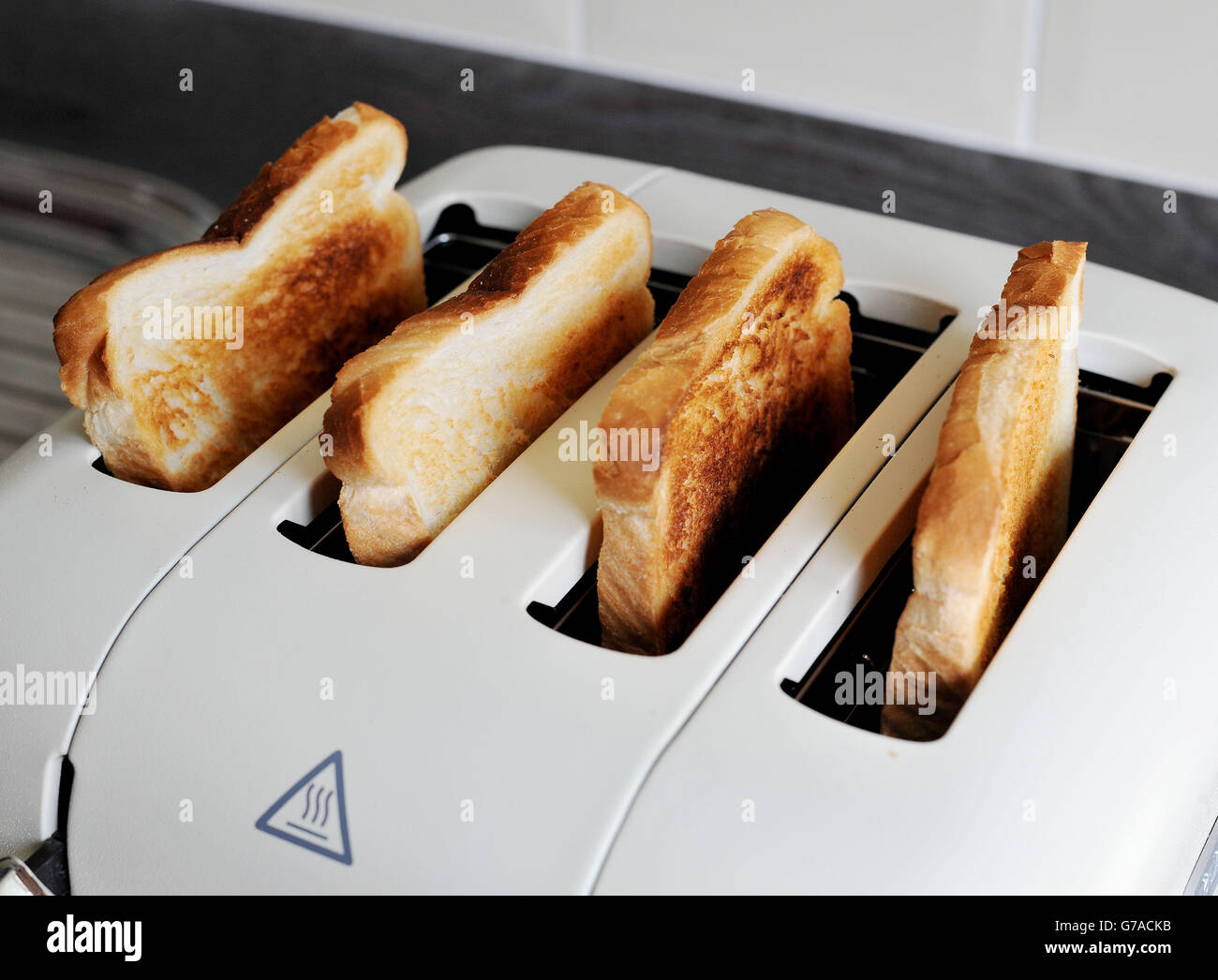 Four slices of white toasted bread in a four slice toaster Stock Photo ...