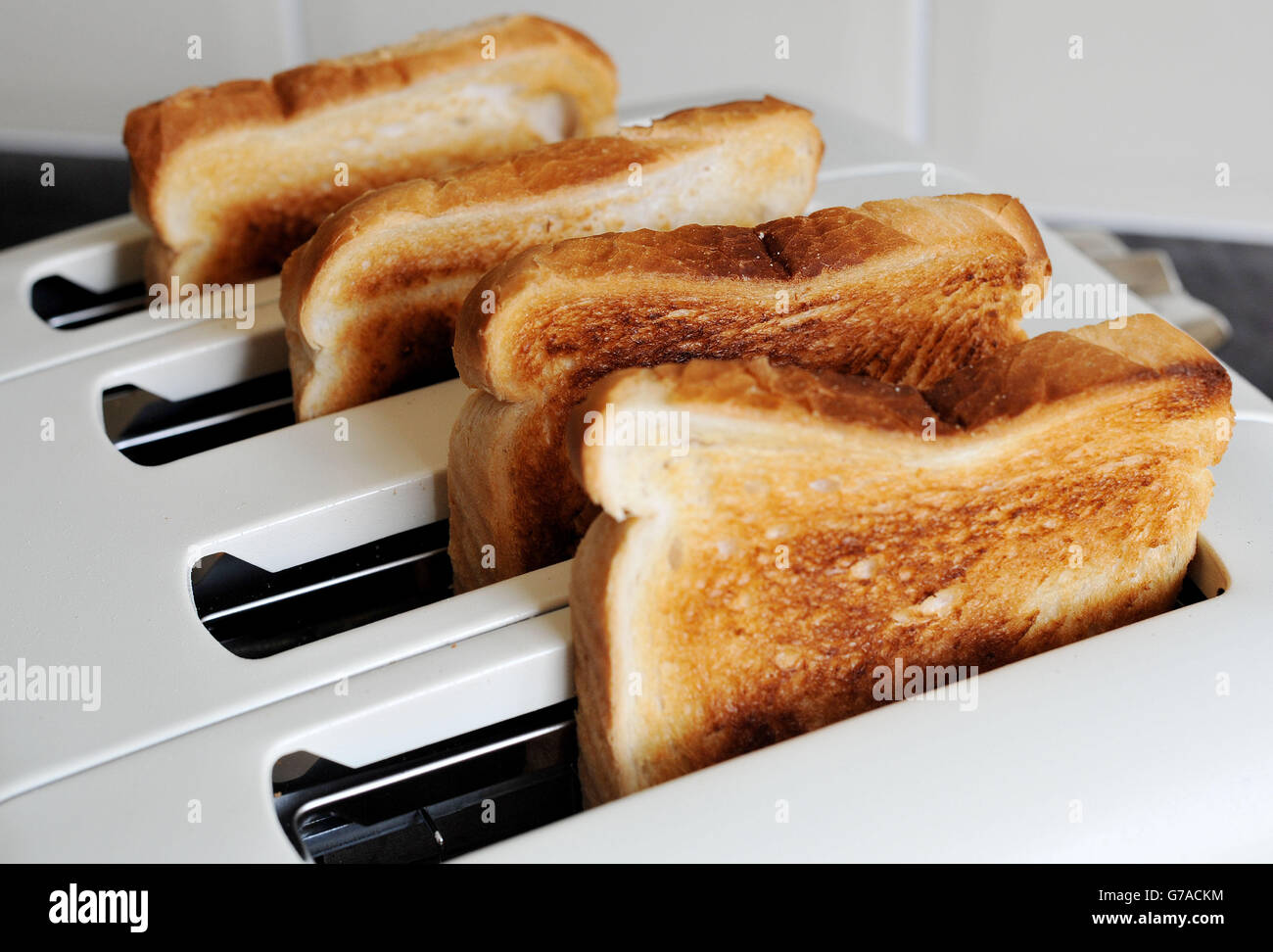 Four slices of white toasted bread in a four slice toaster Stock Photo ...