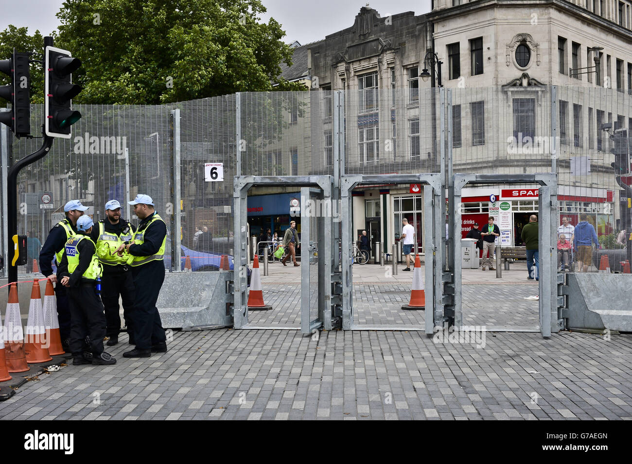 Police guard security fencing and pedestrian checkpoints, which are set ...