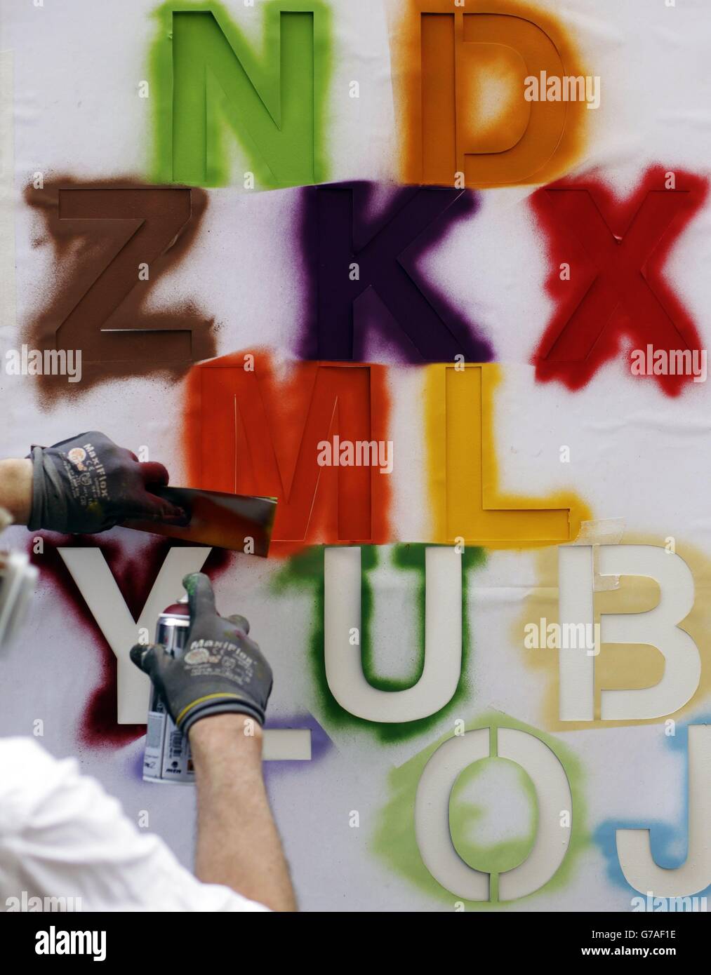 MORGAN works on a piece ahead of the official opening of OUTVASION ...