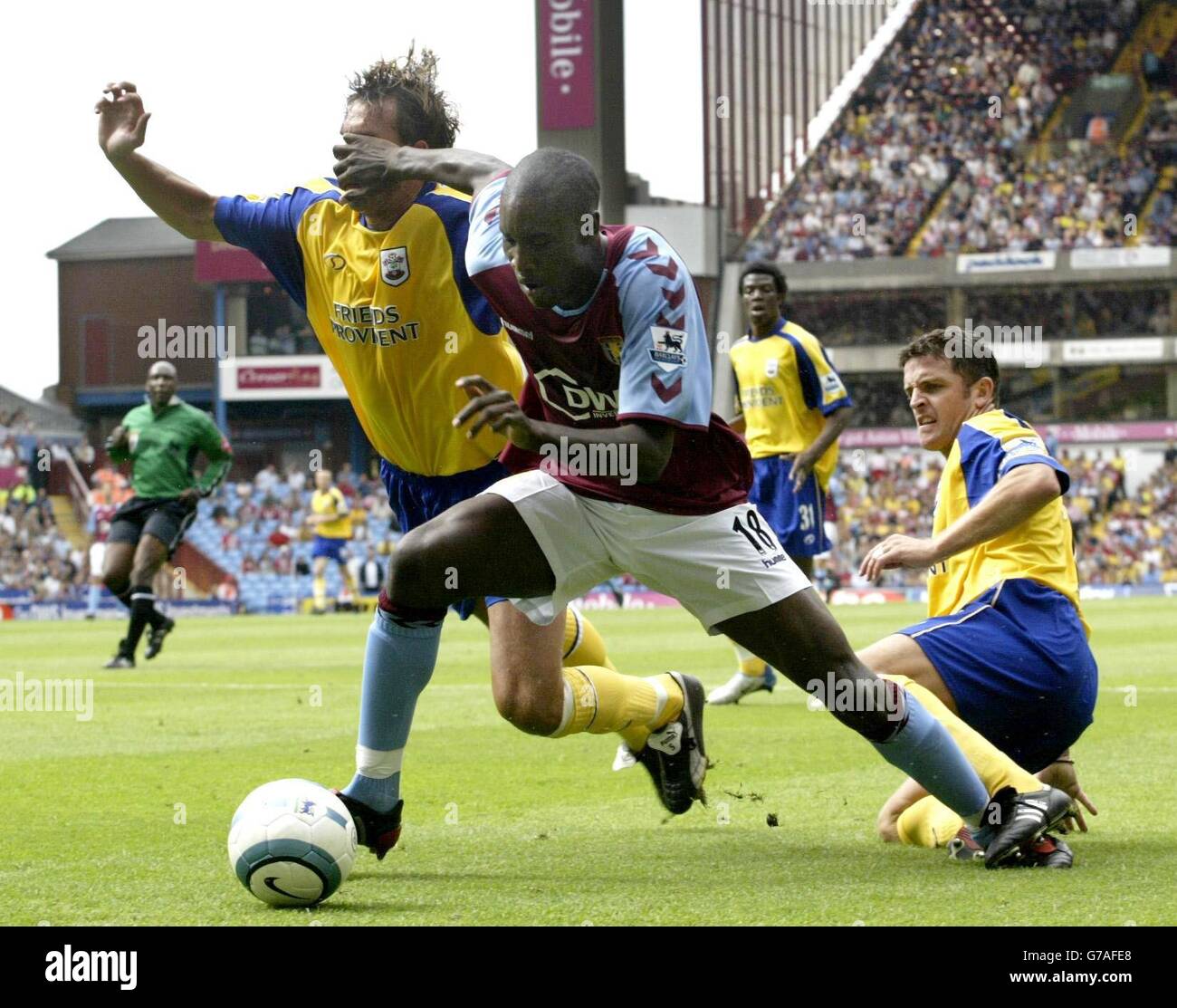 Aston Villa's Carlton Cole skips around the tackle from Southampton ...