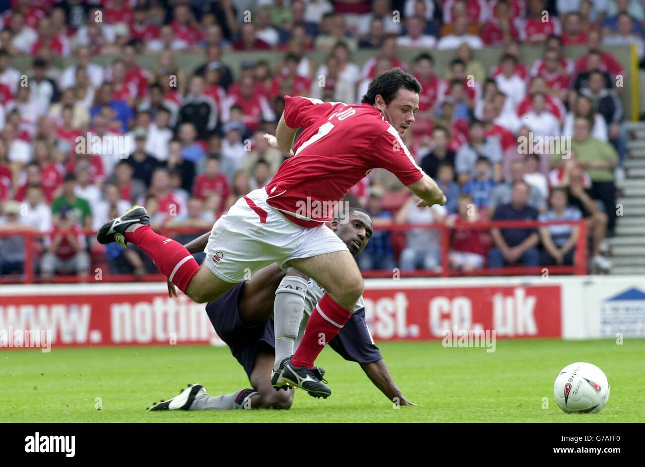 Nottingham Forest's Andy Reid goes flying as Crewe's Justin Cochrane ...