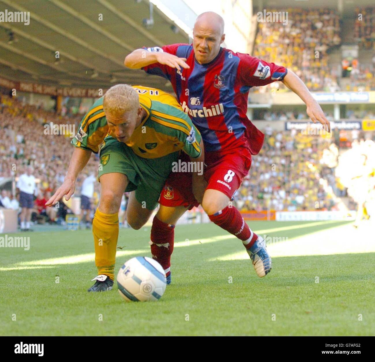 Norwich City's Gary Holt (left) takes a tumble alongside Crystal Palace ...