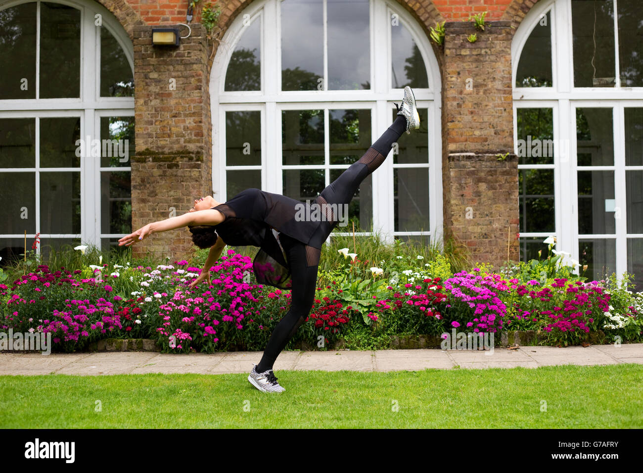 A jazz dancer performing a kick outdoors Stock Photo - Alamy