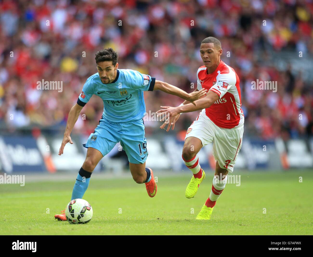 Manchester City's Jesus Navas (left) and Arsenal's Kieran Gibbs battle ...