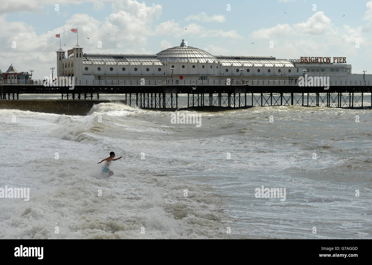 A swimmer enters tha water at Brighton beach as the effects of ex ...