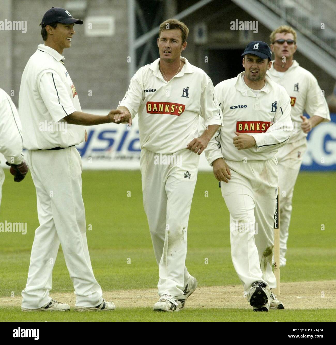 Warwickshire bowler Dewald Pretorius (centre) celebrates with Mark Wagh ...