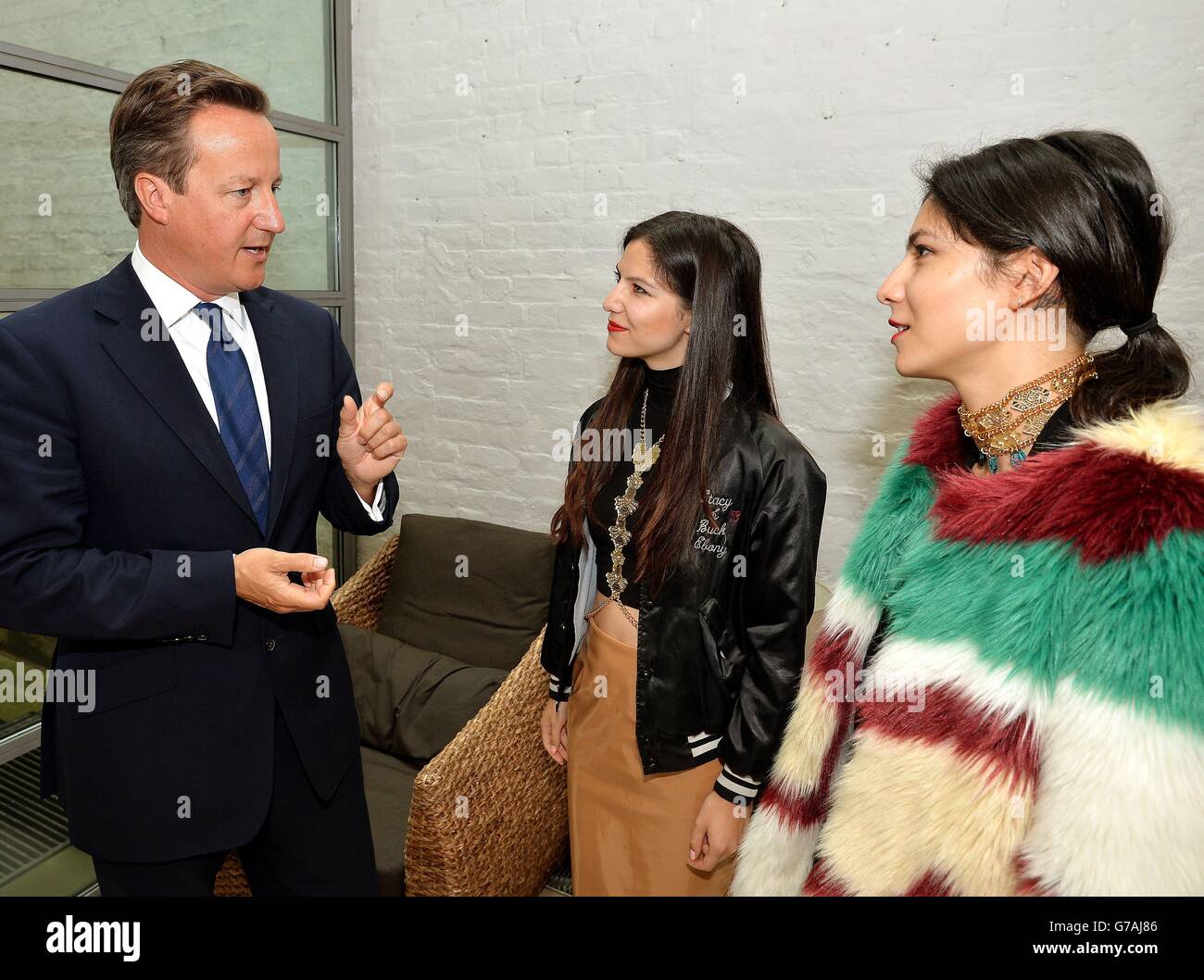 Prime Minister David Cameron speaks with designers and makers Tida ...