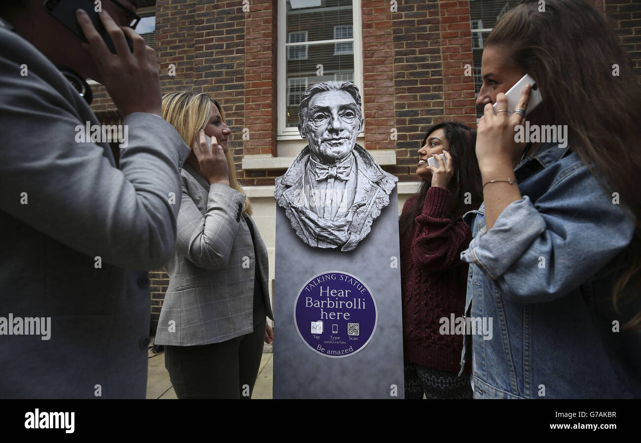 Talking Statues launch. People listen to a talking statue on their ...