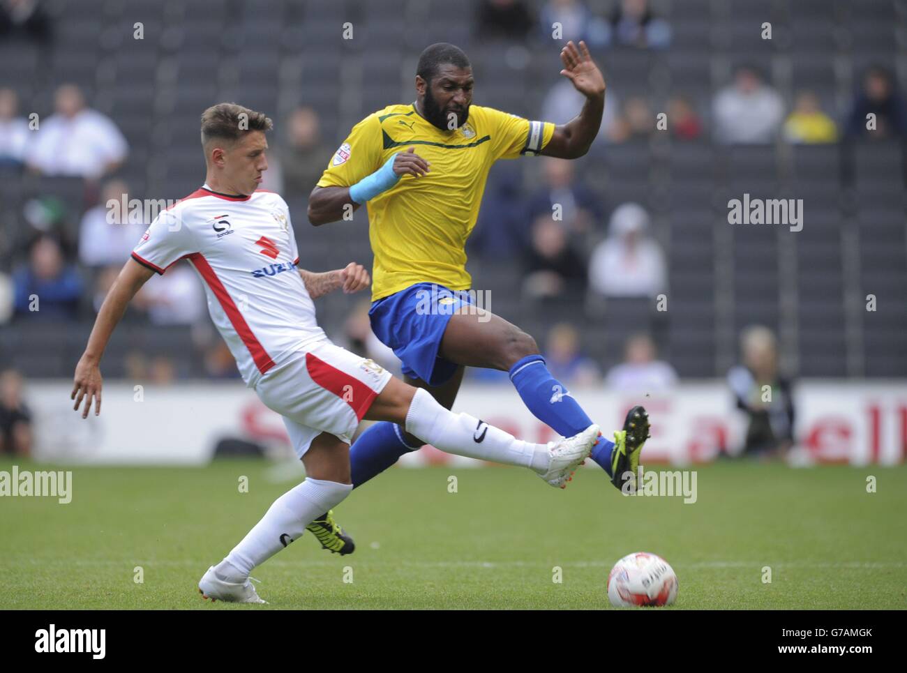 Coventry City's Reda Johnson (right) challenges Milton Keynes Dons Tom ...