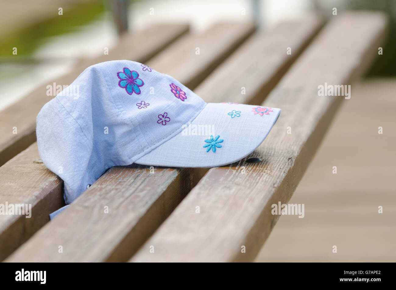 Forgotten cap girl lying on a bench Stock Photo - Alamy