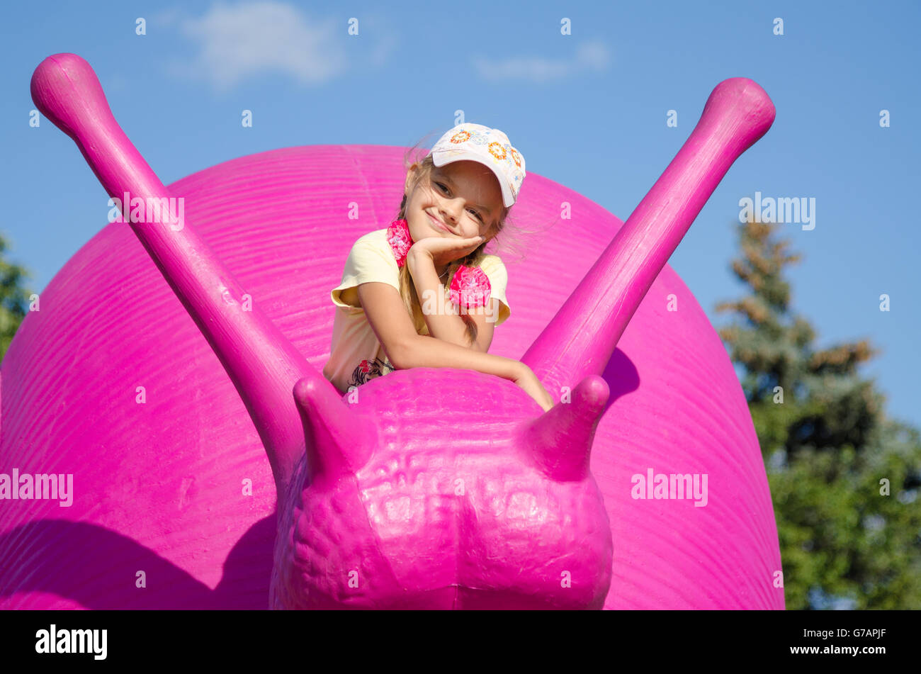 Moscow, Russia August 10, 2015: Six-year girl on a pink snail, exhibit ...