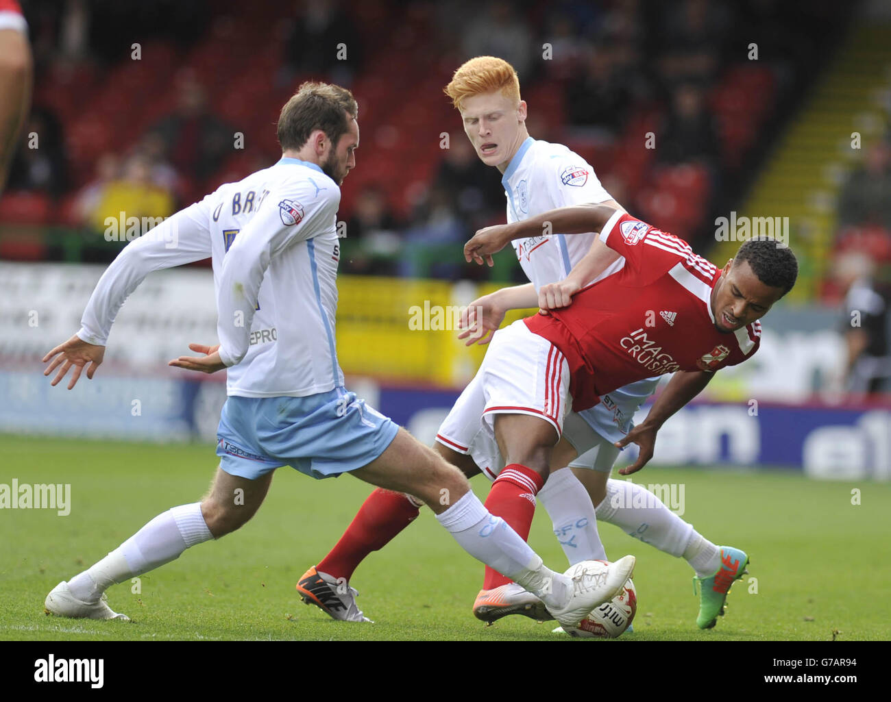Swindon Town's Louis Thompson and Coventry City's Ryan Harris and Jon O ...