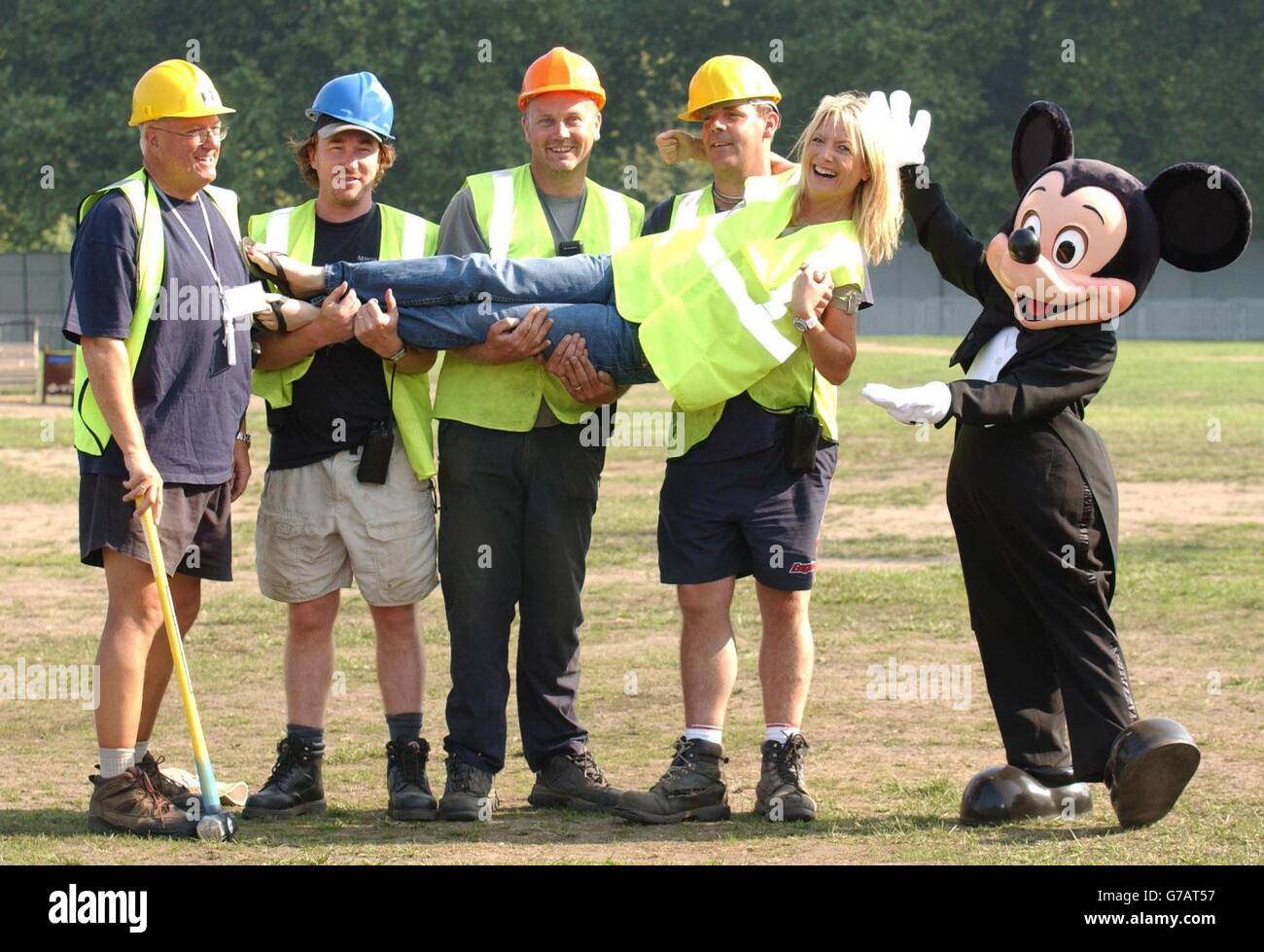 Host of the event Gaby Roslin poses with Mickey Mouse in front of the ...