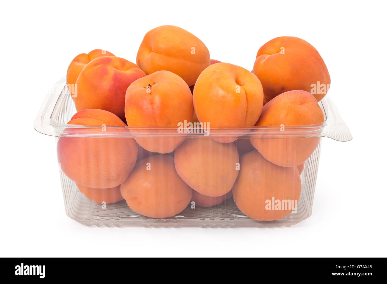 Box or punnet of fresh ripe organic apricots isolated on white ...