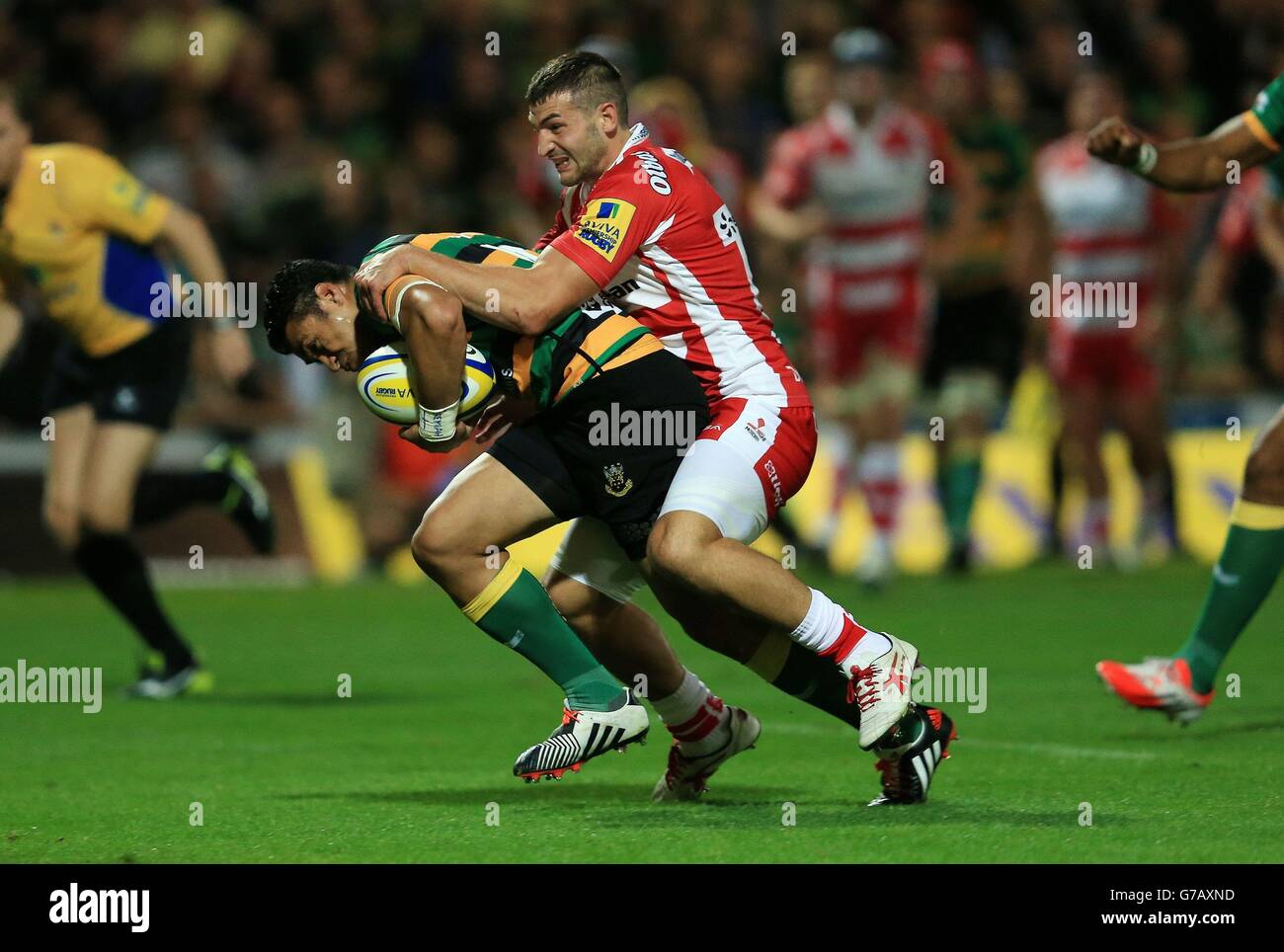 Northampton's George Pisi beats the tackle of Gloucester's Jonny May to ...