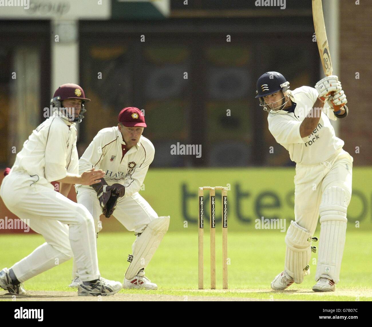 Middlesex batsman Owais Shah drives past Northamptonshire short fielder ...
