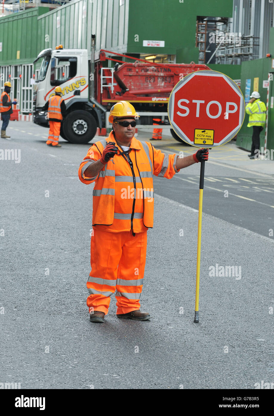 Stock photo of a traffic marshall at the construction site of the new offices of Bloomberg ...