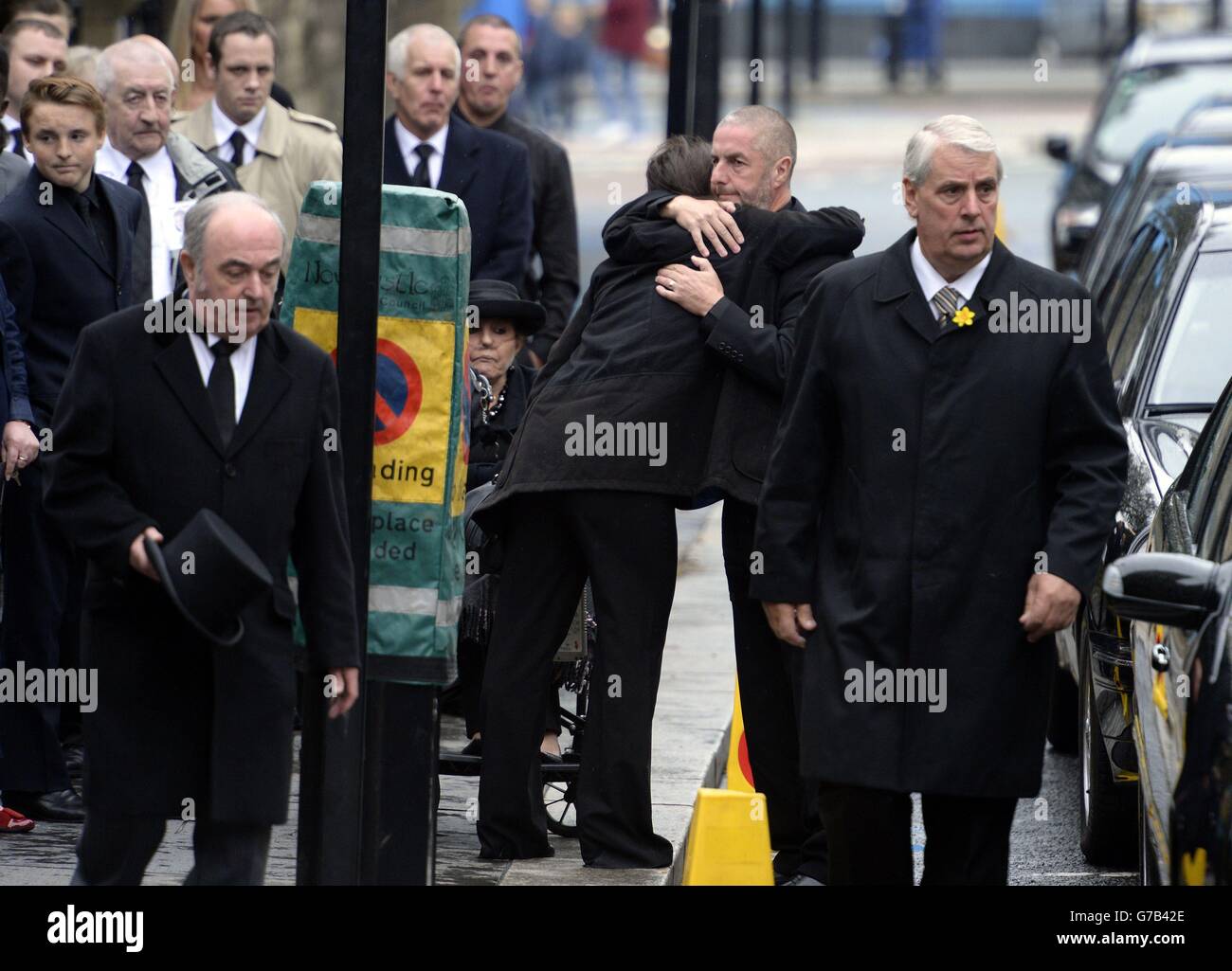 Barry Sweeney (second right) is hugged before the funeral for his son ...