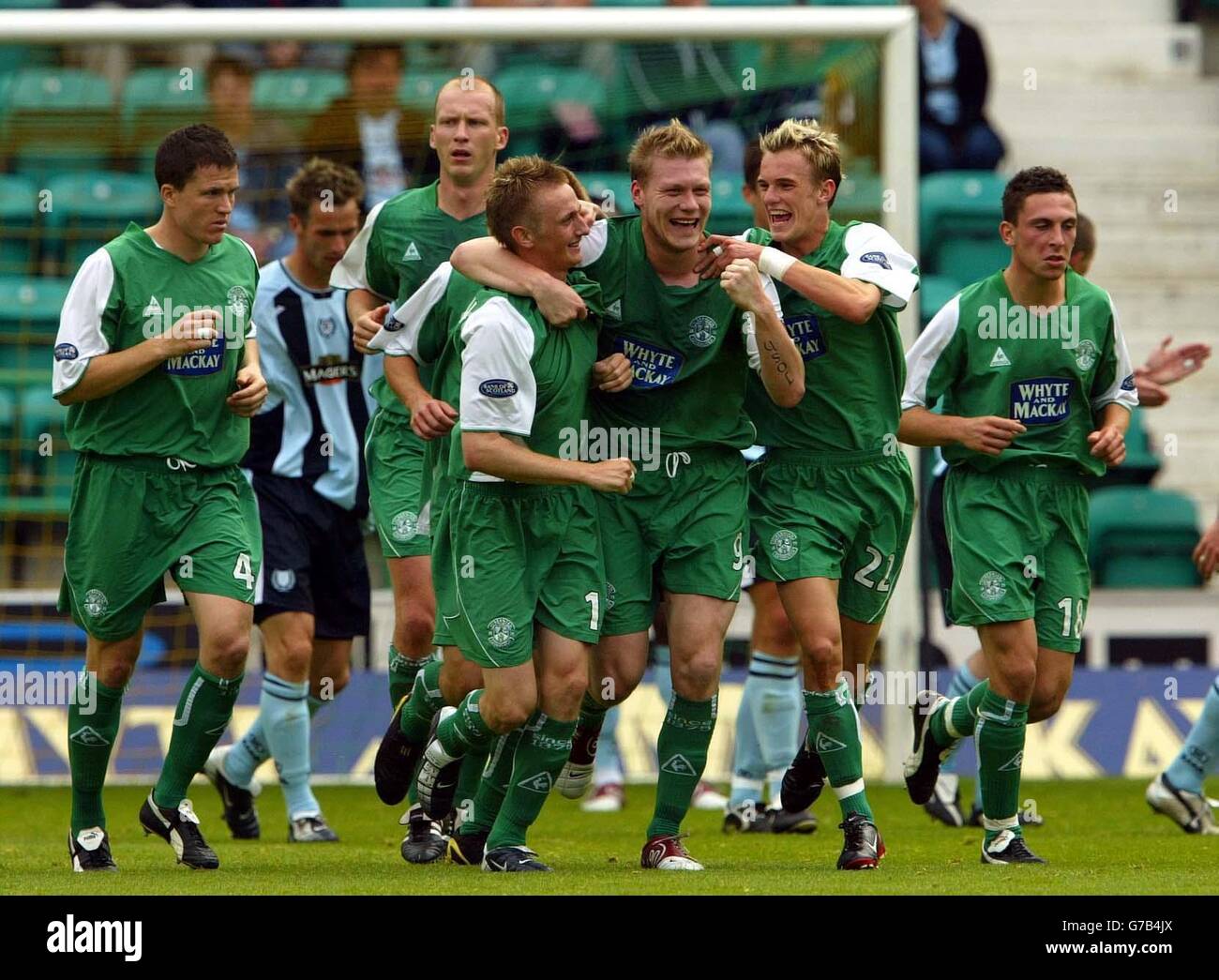 Hibernian's Derek Riordan (centre celebrates with team-mates after ...
