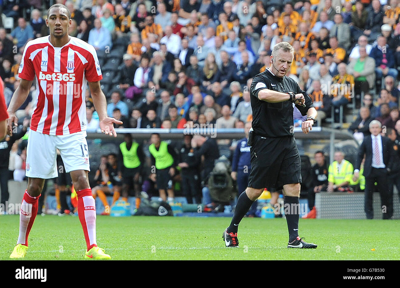 Referee Jonathan Moss checks the goal line technology on his watch ...