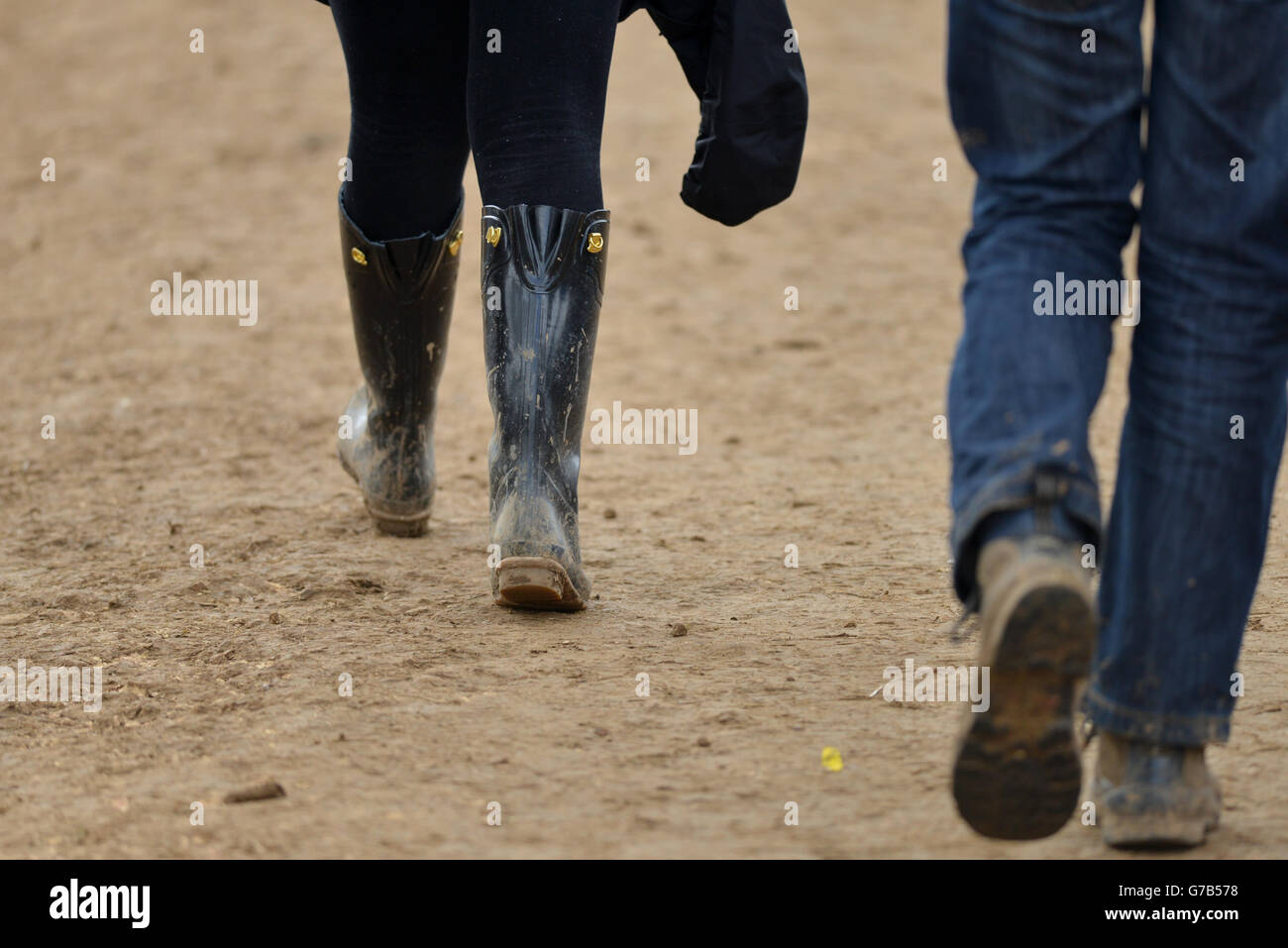 Festival goers walk through mud during day three of Leeds Festival in ...