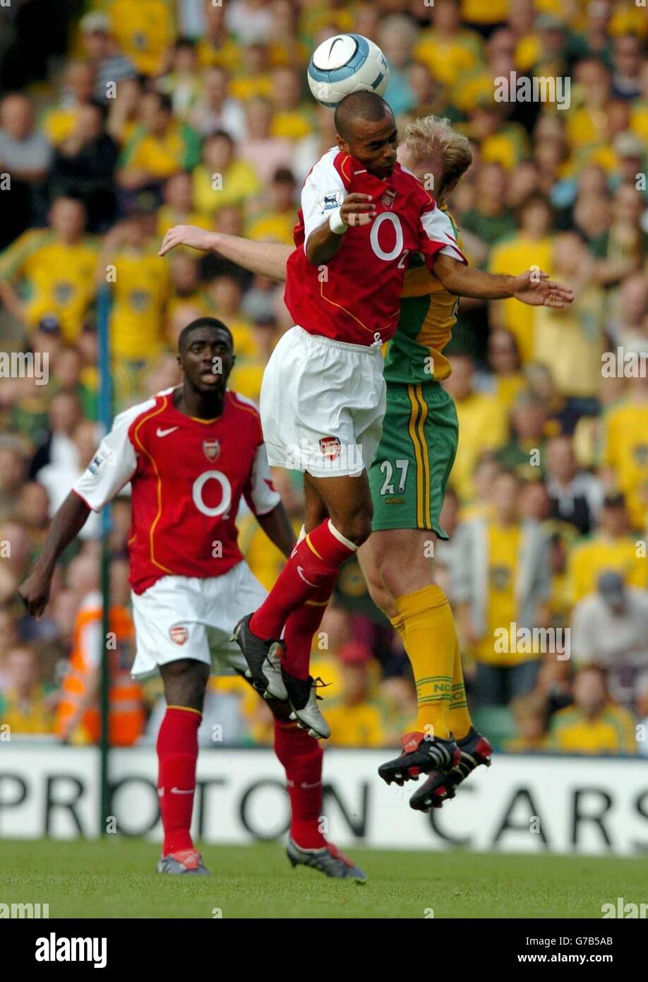 Arsenal's Ashley Cole climbs with Norwich City's Gary Doherty, during ...