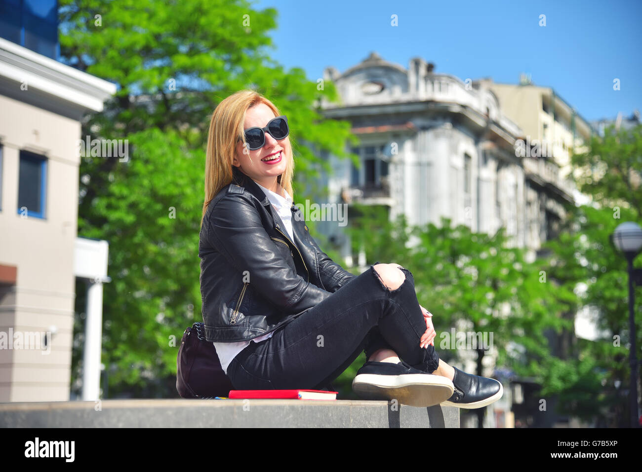 happy hipster girl sitting on roof Stock Photo - Alamy