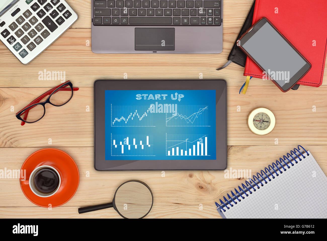 Digital tablet with start up concept on screen and many business ...