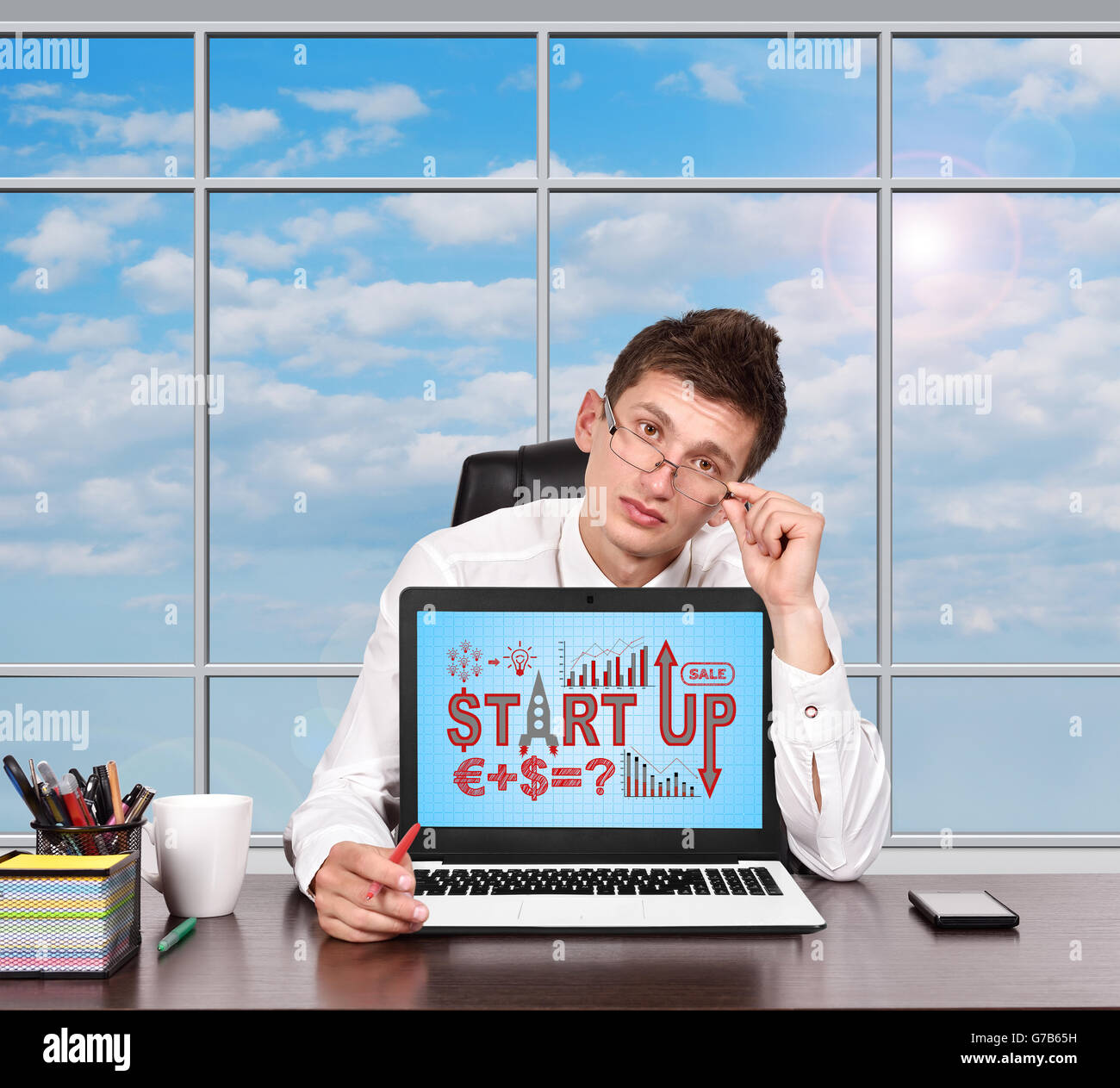 Young Businessman In Office and Laptop with Start Up Scheme Stock Photo ...