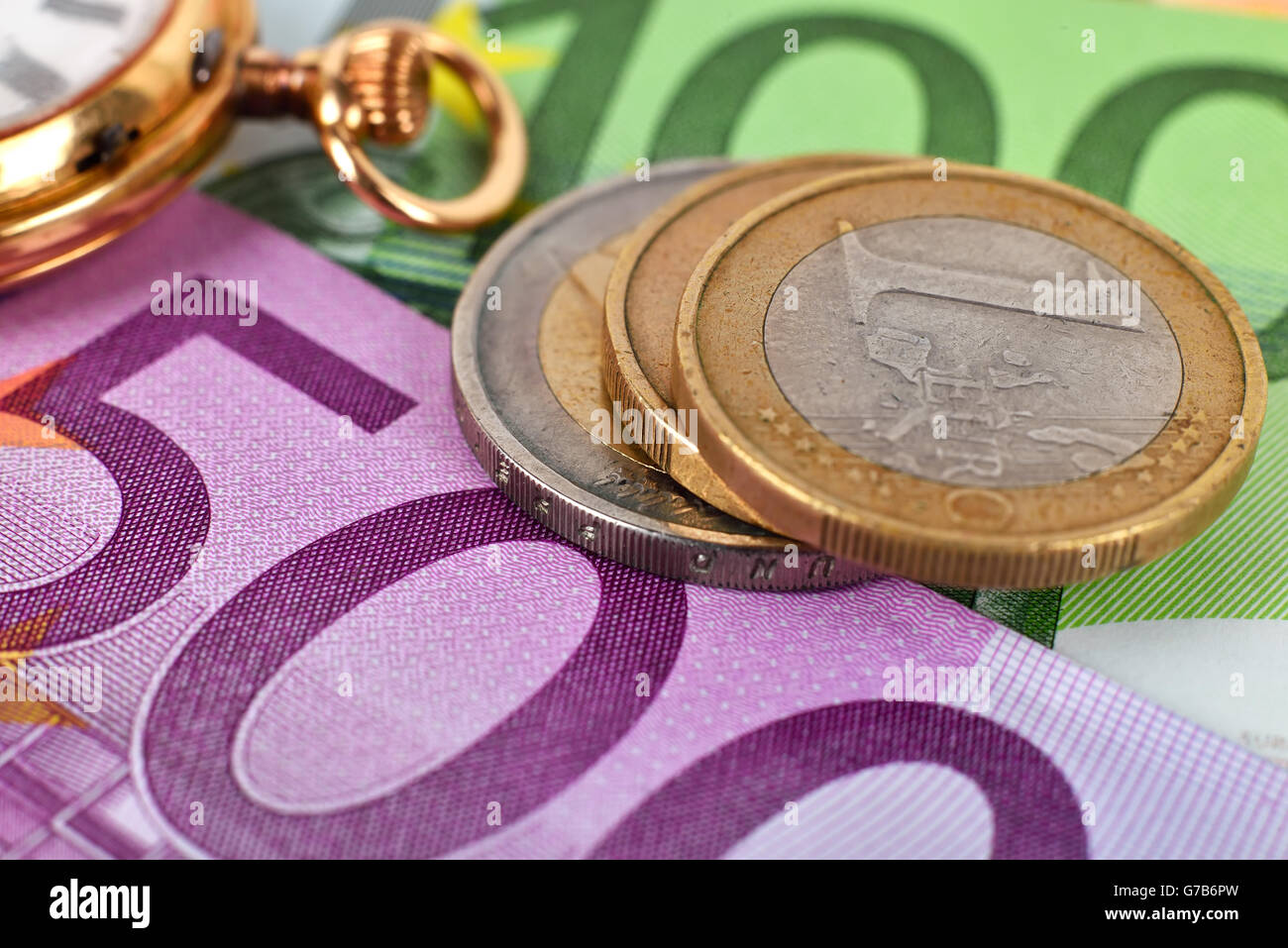 Euro coins, banknotes and pocket watch, close up Stock Photo - Alamy